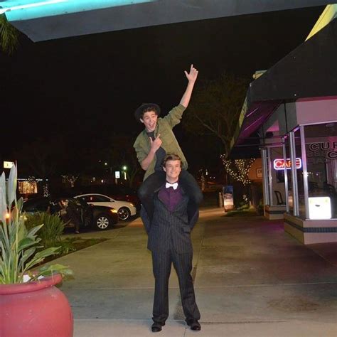 Two Men In Tuxedos Are Posing For The Camera Outside At Night With