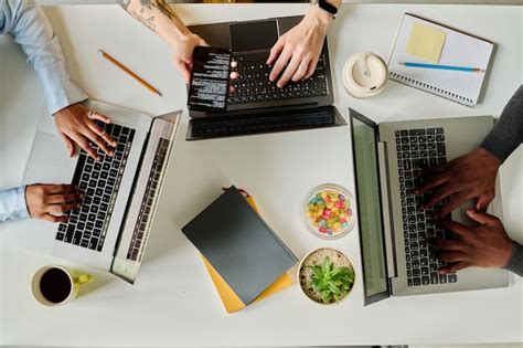 Premium Photo Top View Of Group Of Programmers Working Online On Computers At Table They