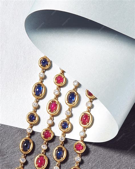 Free Photo High Angle Shot Of Bracelets With Pink And Blue Beads On A White Background