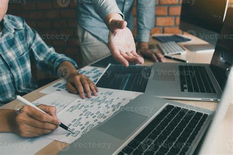 Two Software Developers Are Analyzing Together About The Code Written