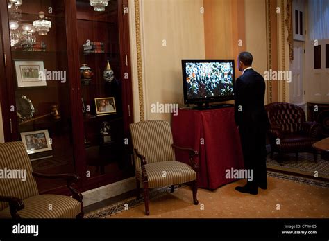 President Barack Obama Watches A Monitor In House Speaker John Boehner