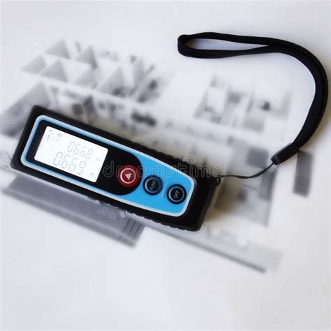 Laser Ruler On The Table With Drawings And Layout Of The Apartment