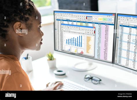 African Woman Analyst Conducting Data Analysis On Spreadsheets Stock Photo Alamy