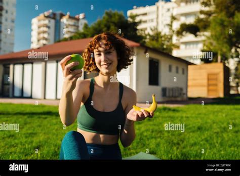 Young Redhead Sportive Woman Wearing Green Sports Bra And Blue Yoga