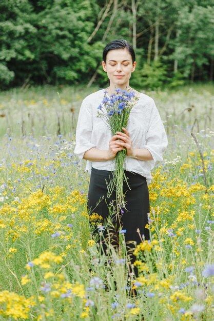 Premium Photo Beautiful Girl Among The Summer Field With Wildflowers