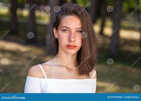 Young Beautiful Brown Haired Girl With Freckles On Her Face Stock Image