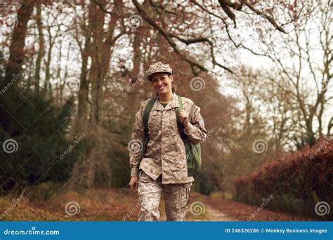 American Female Soldier In Uniform Carrying Kitbag Returning Home On