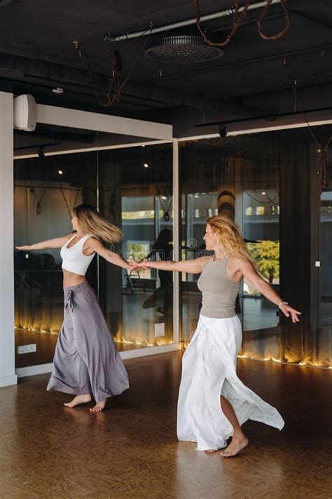 Two Women In Sportswear Are Doing Dance Yoga In The Gym Stock Image