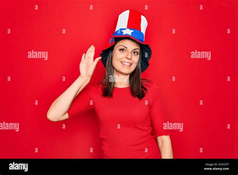 Young Beautiful Brunette Woman Wearing United States Hat Celebrating