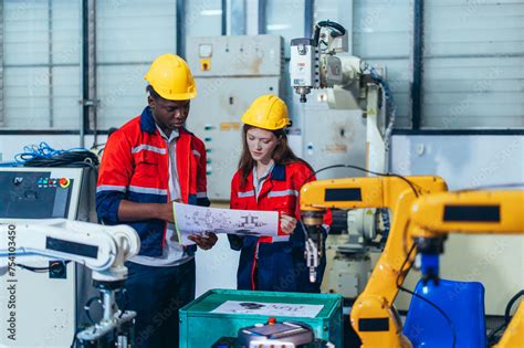 Trainees Programing Robotic Arm In Practical Lesson At Robotics Academy