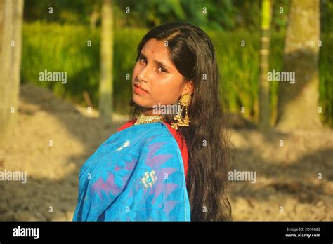 Close Up Of Teenage Indian Bengali Girl Wearing Blue Sari With Long