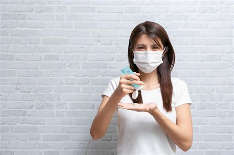 Premium Photo Portrait Of Young Woman Drinking Glass Against Wall