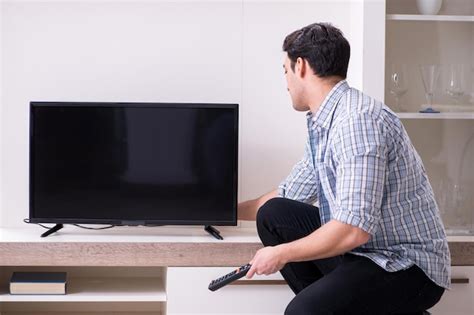Premium Photo Man Trying To Fix Broken Tv