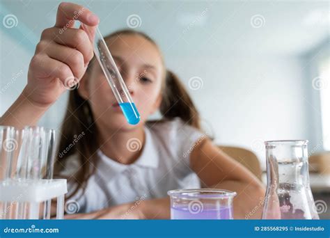 A Schoolgirl Conducts Experiments In A Chemistry Lesson Girl Pouring