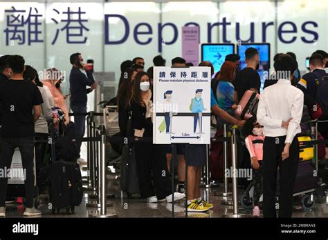 Passengers Wearing Masks Line Up At The Check In Counter For Bangkok In