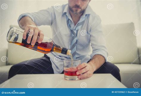 Alcoholic Drunk Business Man In Loose Time On Couch Drinking Whisky