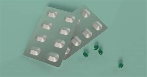 Two Pills And Three Green Pills On A Green Background Photo Medicine