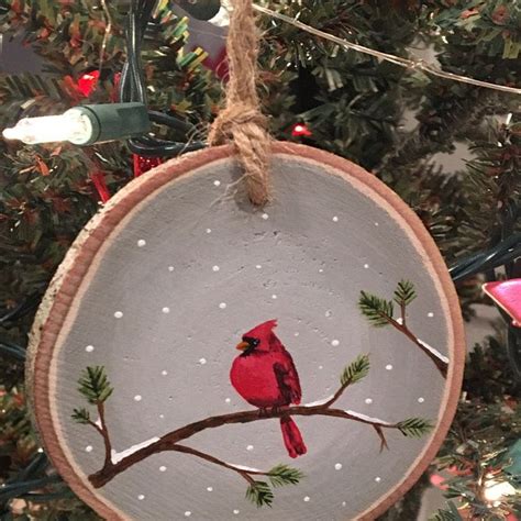 A Christmas Ornament Hanging From A Tree With A Cardinal On Its Branch