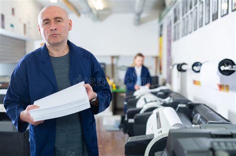 Portrait Of An Employee Of Printing House With Stack Of Paper In His Hands Stock Image Image