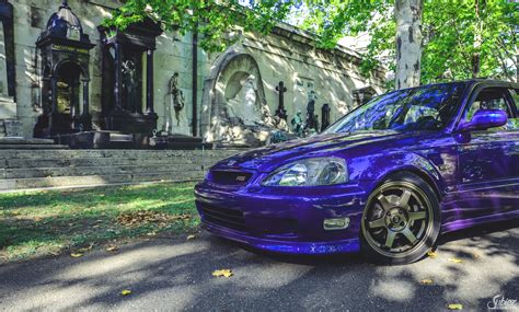 Purple Honda Civic Sedan Parked In Front Of Building