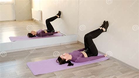 Athletic 30 Year Woman Is Doing Bridge Exercise Stepping By Wall Lying