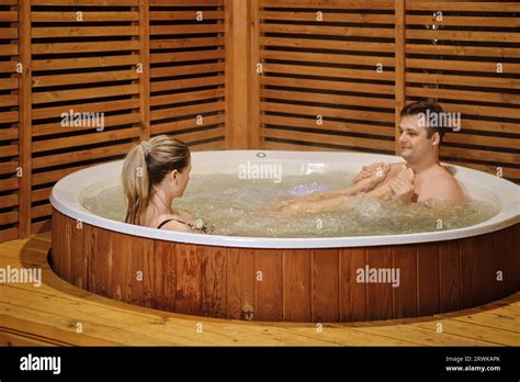 Playful Woman Put Her Feet On Chest Of Her Husband While Relaxing In A