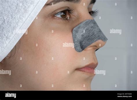 A Woman Sticks A Cleansing Strip On Her Nose Black Dots On The Nose Girl Without Makeup In The