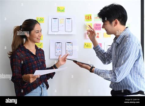 Shot Of Ux Developer And Ui Designer Brainstorming And Discussing About Mobile App Interface