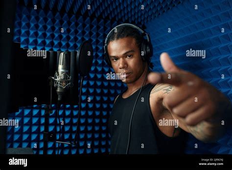 Close Up Of Handsome Young Black Singer Standing In Front Of Microphone Singing Song In