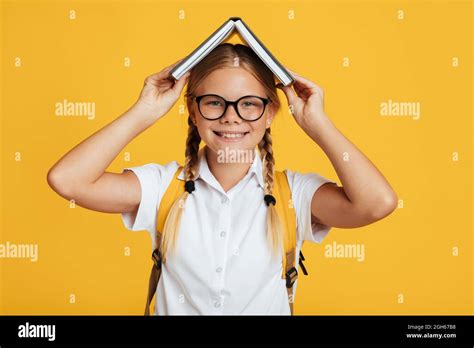 Happy Cute Caucasian Teenager Blonde Girl In Glasses Holding Book On