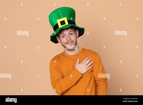 Attractive Young Guy With A Big Green Hat On A Yellow Background Stock