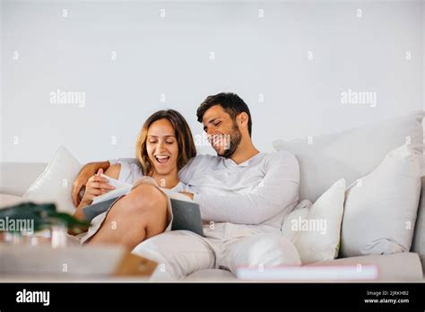 Unshaven Husband Dressed In Domestic Clothes Hugging Happy Wife While