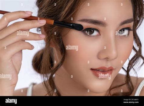 Closeup Gorgeous Young Woman Putting Black Mascara On Her Long