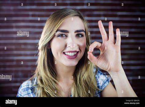 Pretty Blonde Woman Making Signs With Her Fingers Stock Photo Alamy