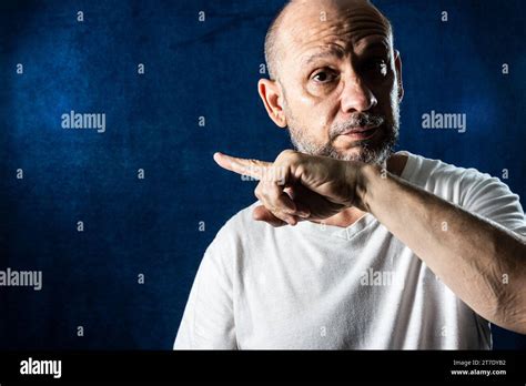 Man Confused Pointing To The Side Sad People Against Blue Background Stock Photo Alamy