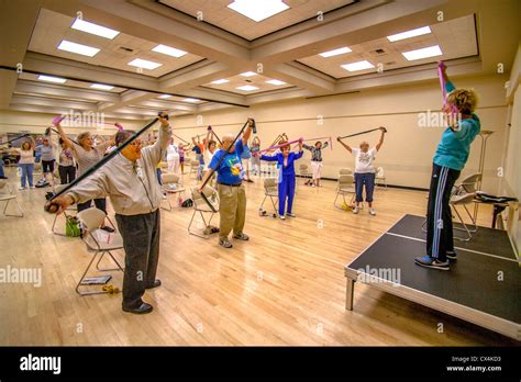 An Instructor Conducts A Chair Exercise Class For Senior Women And Men
