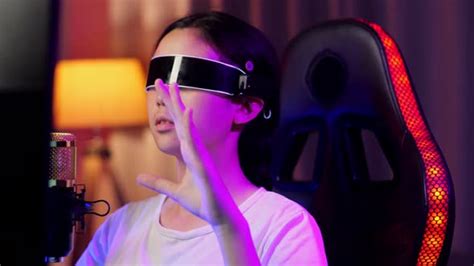 Asian Girl Streamer Playing Game Experience Virtual Reality In Futuristic Goggles Lifestyle