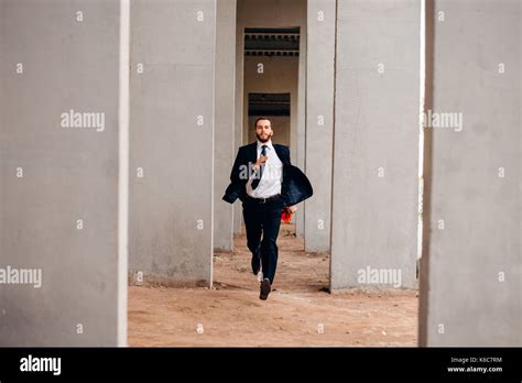 Construction Worker Running From Danger On Construction Site Stock