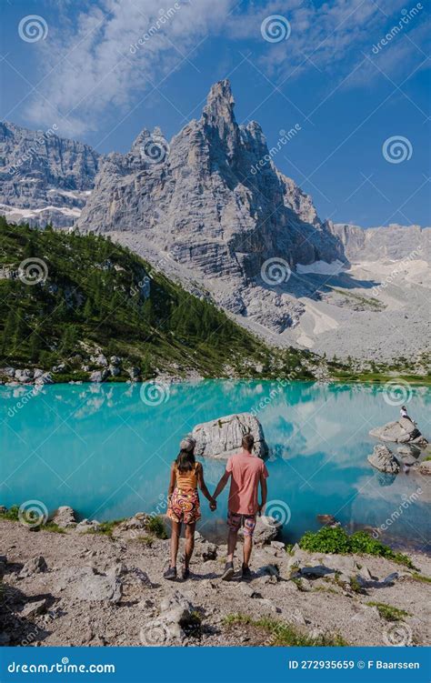 Couple Of Men And Women Visiting Lago Di Sorapis In The Italian
