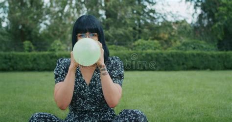 A Happy Woman Inflates Balloons And They Burst Showing That Everything