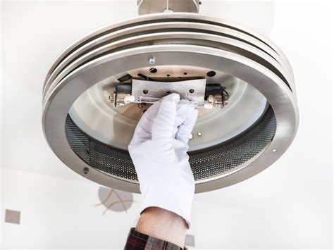 Premium Photo Electrician Fixes Halogen Lamp In Ceiling Light