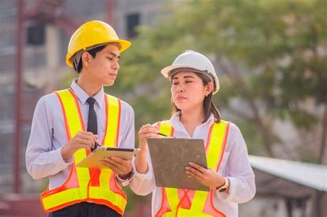 Premium Photo Male And Female Engineer Standing Talking About