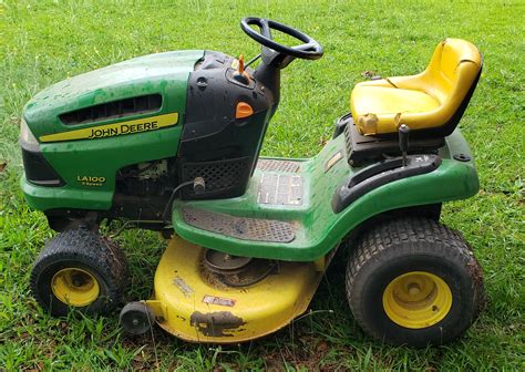At Auction: JOHN DEERE LA100 RIDING MOWER