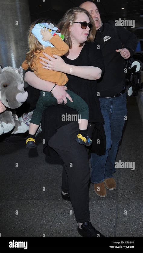 Adele Arrives At Los Angeles International Lax Airport Carrying Her Son Angelo Featuring