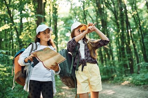 Premium Photo Using The Map Two Girls Is In The Forest Having A