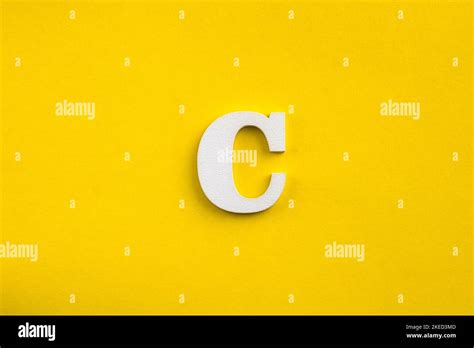 Letter C Uppercase White Wood Letter On Yellow Color Background Stock