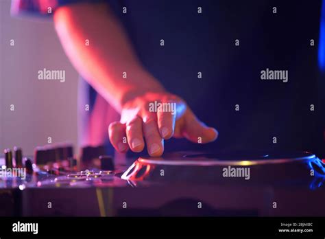 DJ Mixing Tracks On A Mixer In A Nightclub Stock Photo Alamy
