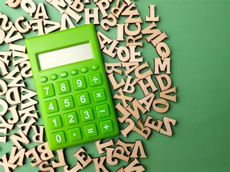 Premium Photo Green Calculator And Wooden Word