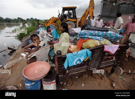 People Who Had To Leave The Banks Of The Overflowing Yamuna River Take Shelter With Their