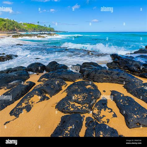 Waves Crash Over Exposed Lava Reef Kauapea Beach Kauai Hawaii USA